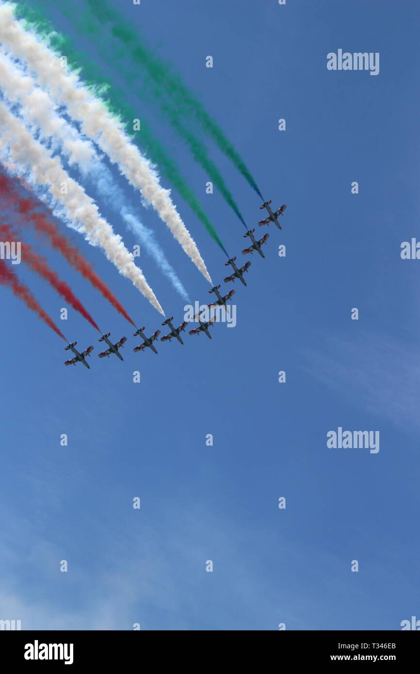 Flying Frecce Tricolori planes with colorful smoke Stock Photo - Alamy