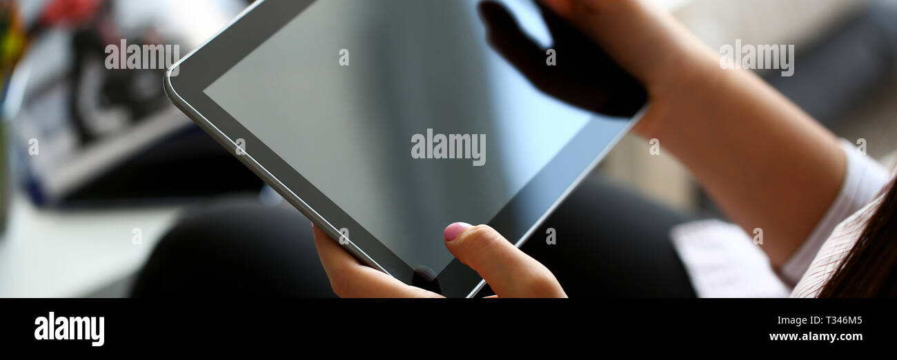 female hand holds tablet in home setting while Stock Photo - Alamy