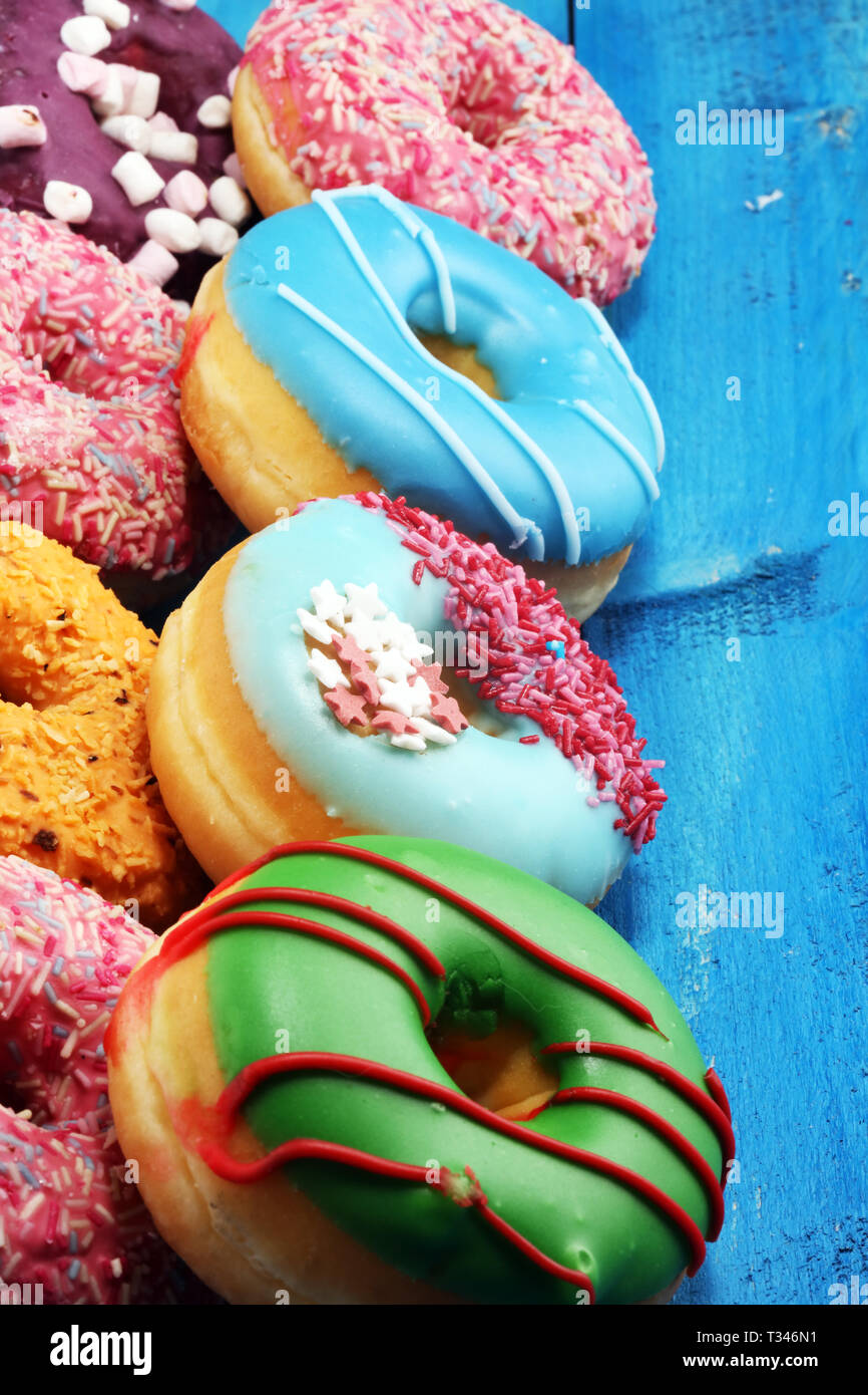assorted donuts with chocolate frosted, pink glazed and sprinkles ...