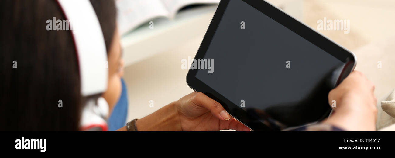 female hand holds tablet in home setting while Stock Photo - Alamy