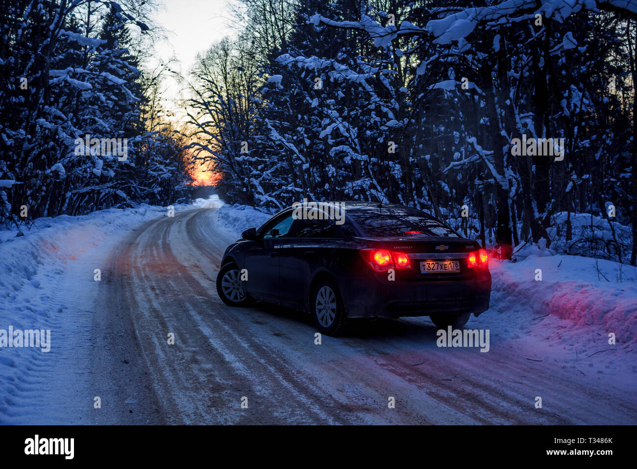 Car on the winter road in the evening. Night road. Road outside the ...