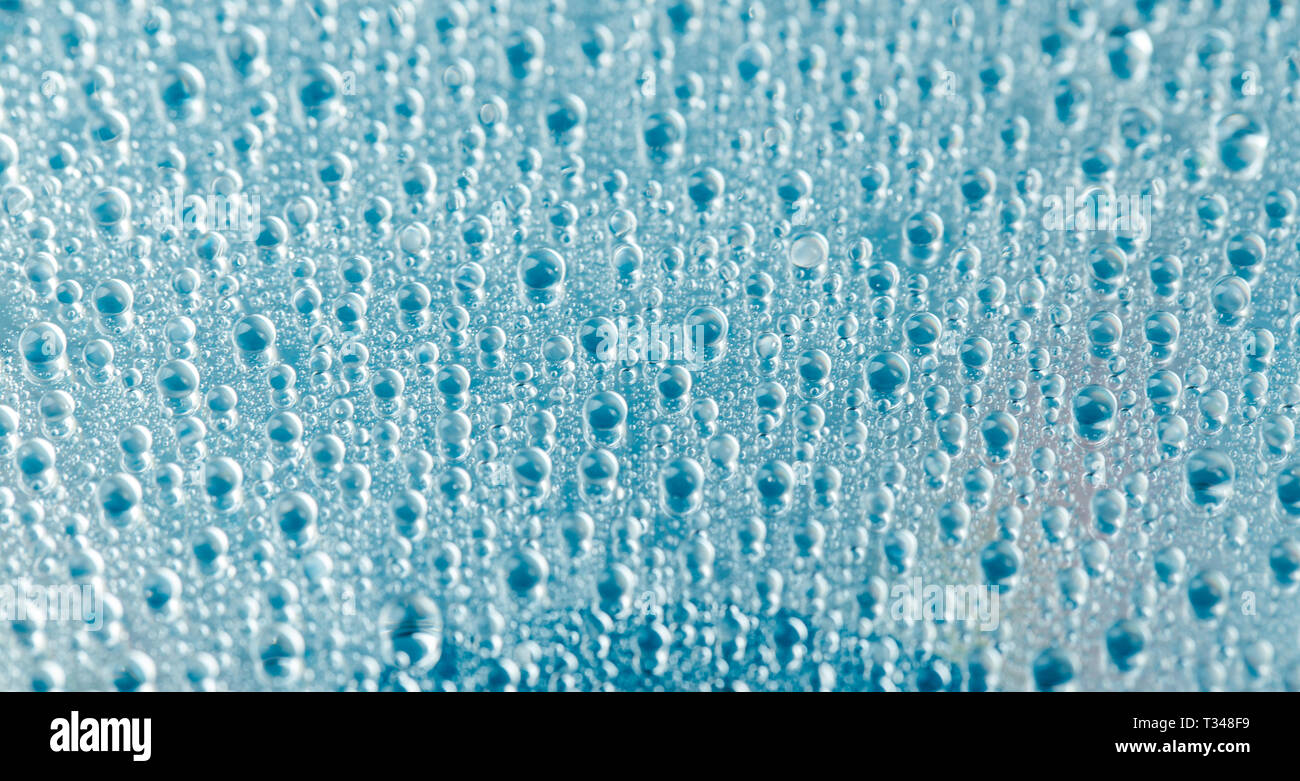 Water drops on blue background. Close up. Long wide banner Stock Photo ...