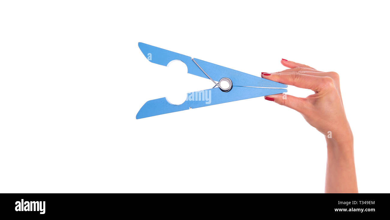 Big wooden clothespin in a female hand on white background Stock Photo ...