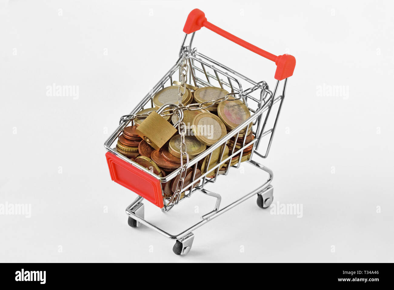 Shopping cart full of money with chain and padlock on white background ...