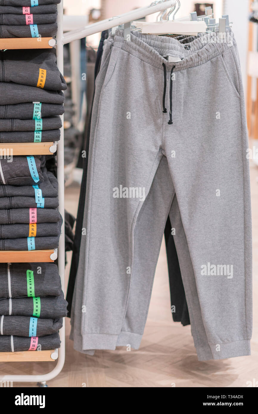 Neat stacks of folded clothing on the shop shelves. Color folding shirt ...