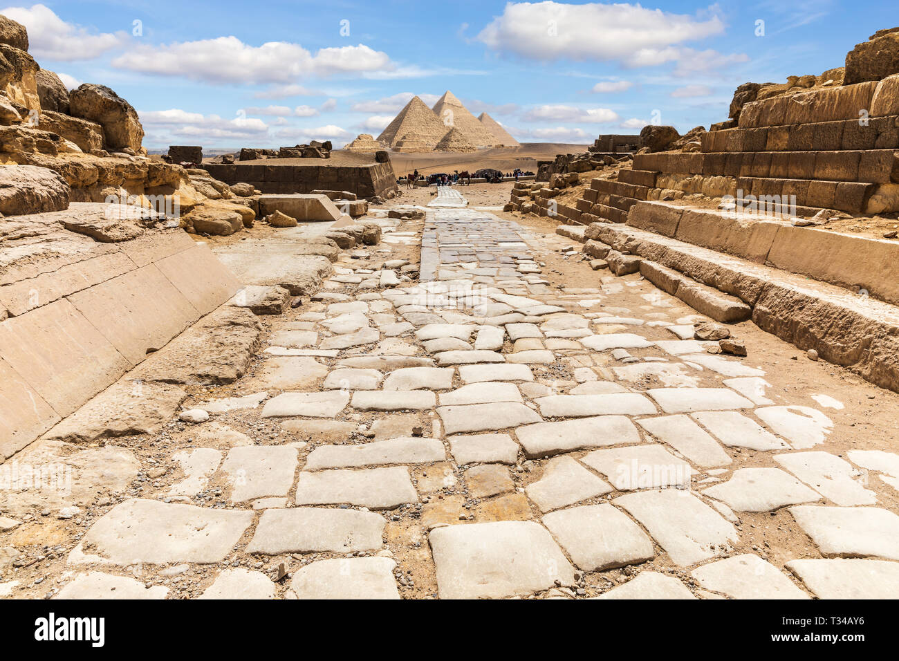 Giza Temple ruins and the road to the Great Pyramids, Egypt Stock Photo ...