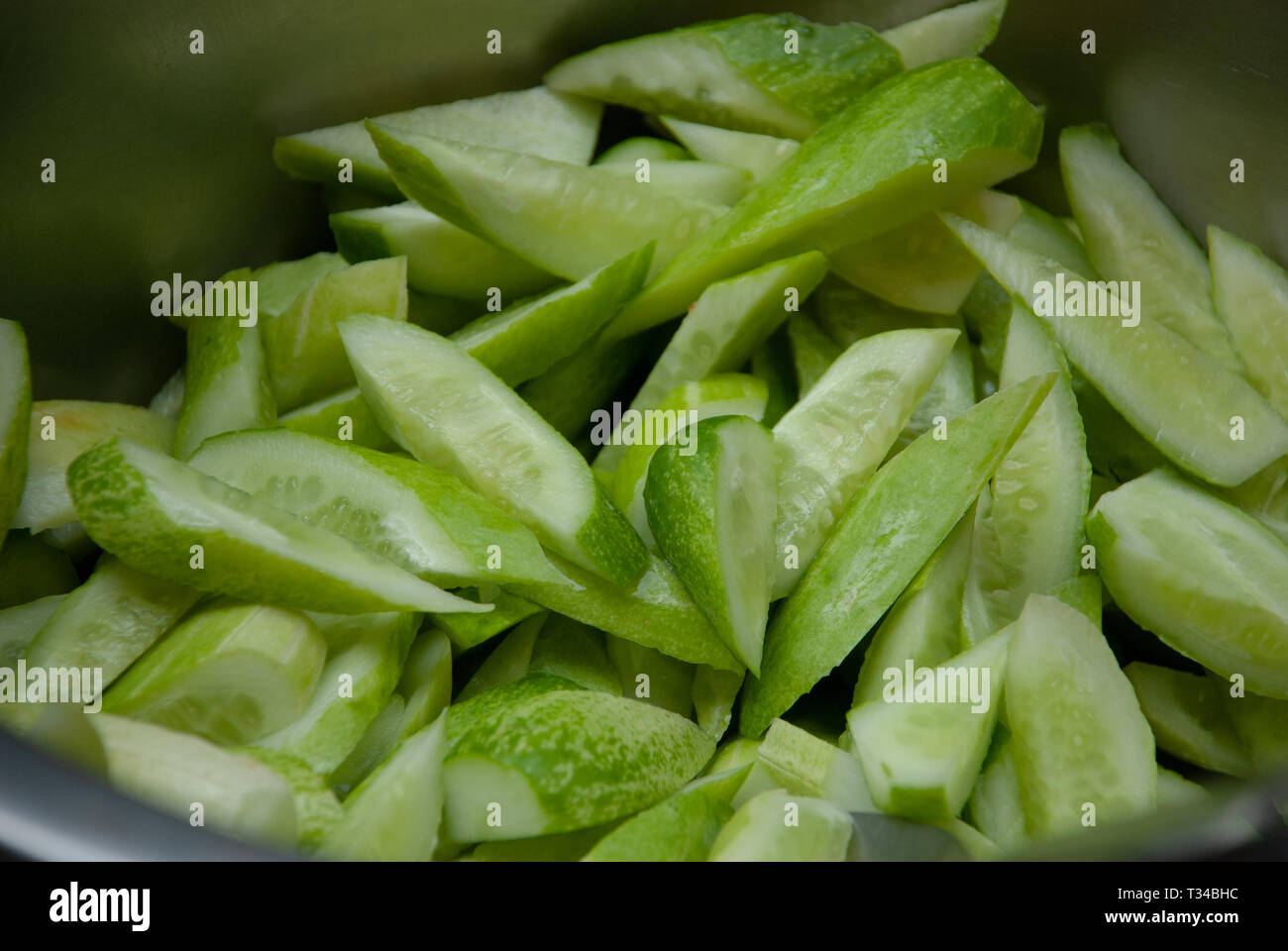 Bowl full of cucumbers cut into slices Stock Photo - Alamy