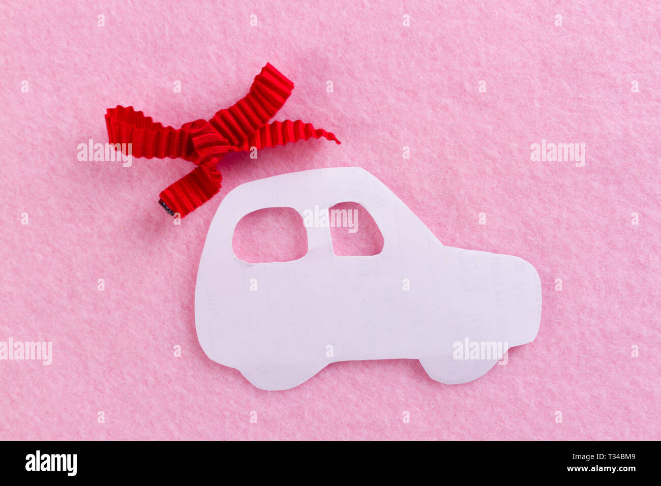car as a gift on pink background Stock Photo - Alamy
