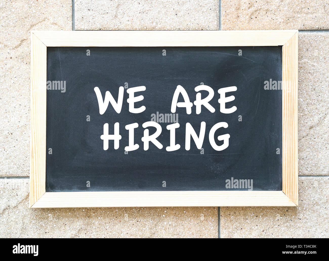 We are hiring, words on blackboard, business and employment concepts ...