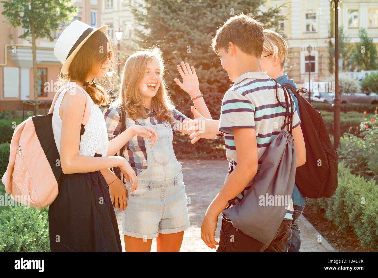 Meeting smiling friends teenagers in the city, happy young people ...