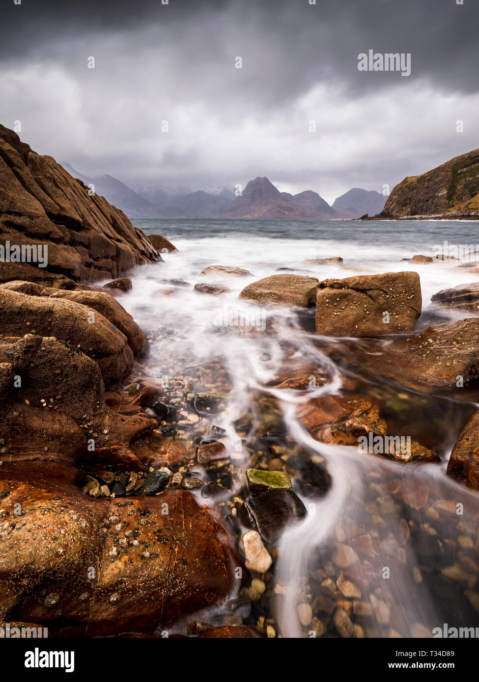 Lines flowing around the rocks as waves come in and out leading to the ...