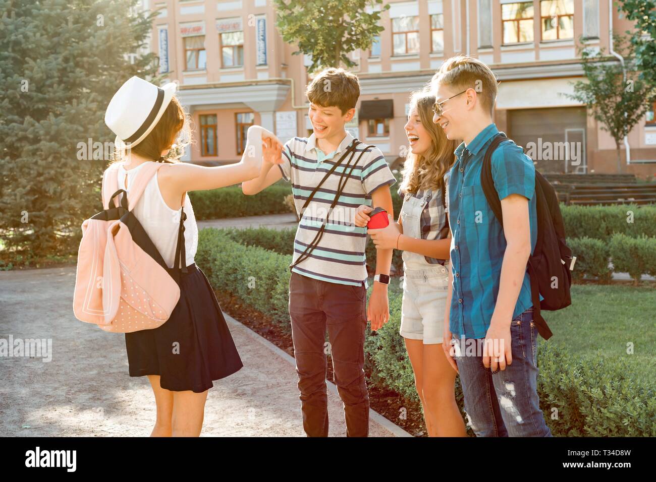 Meeting smiling friends teenagers in the city, happy young people ...