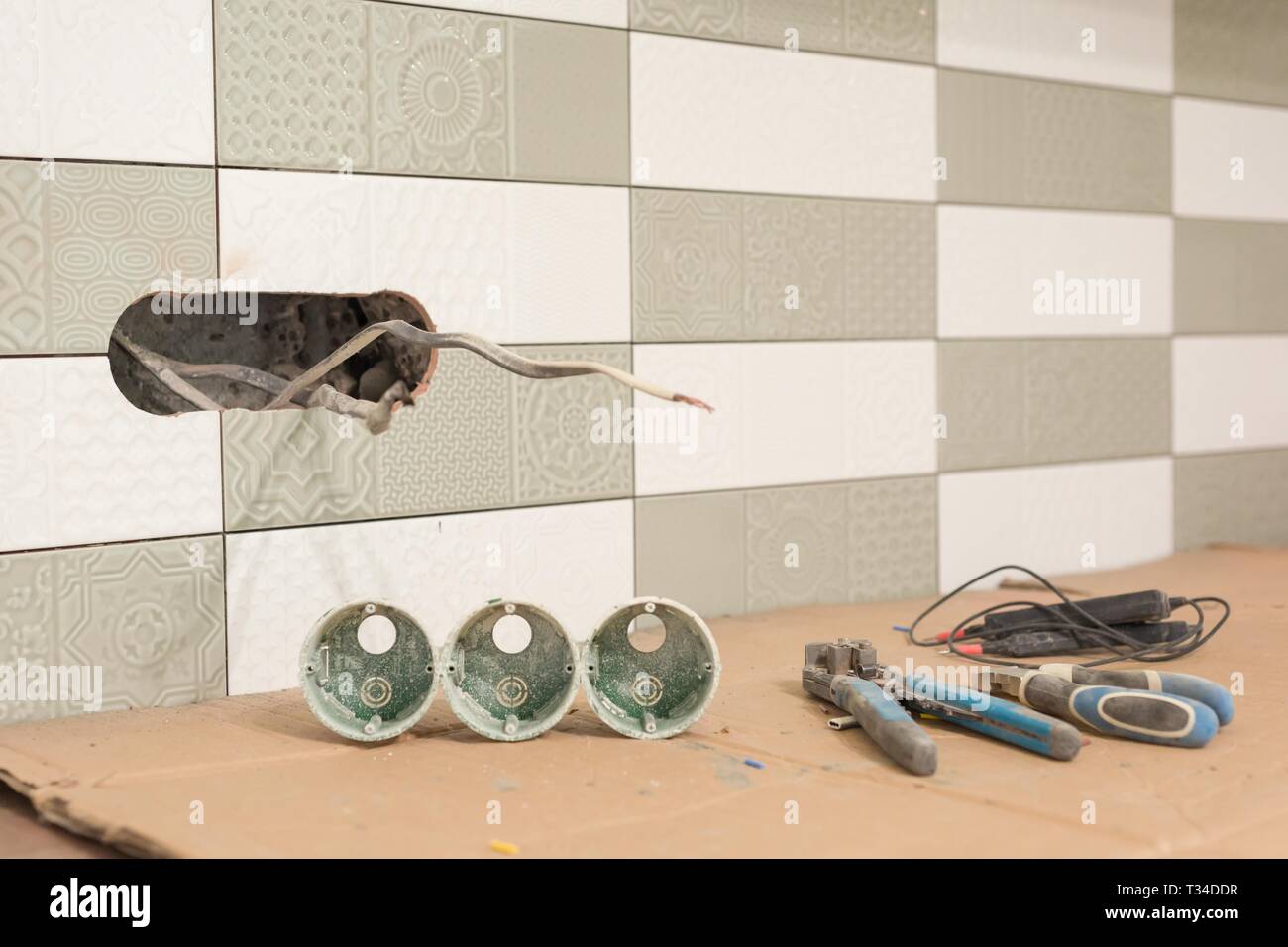 Preparing to install an electrical outlet. Closeup of professional ...