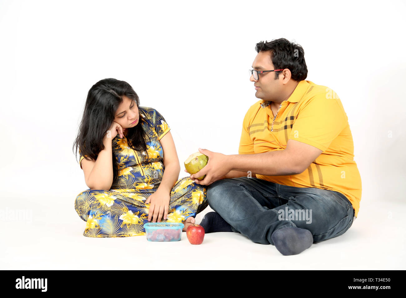 Man is giving coconut water pregnant lady. Isolated on the white ...
