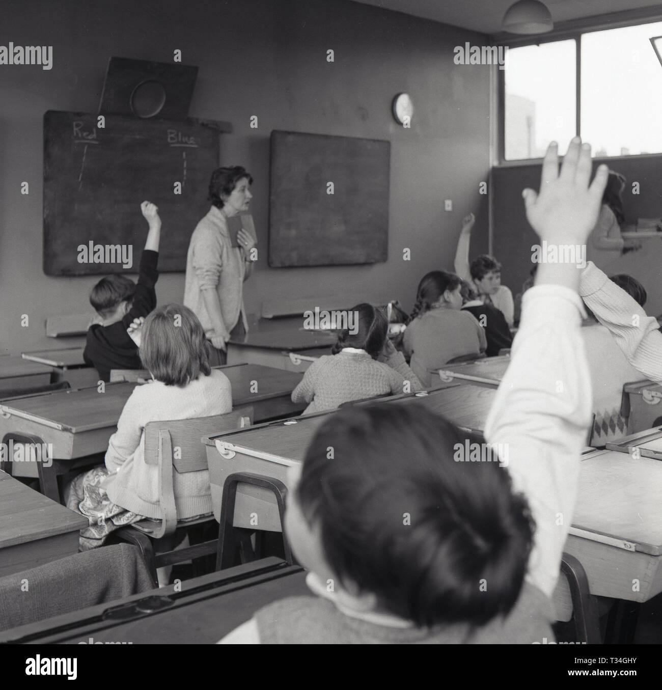 1960s, hands-up, historical plcture of young school children in a class ...