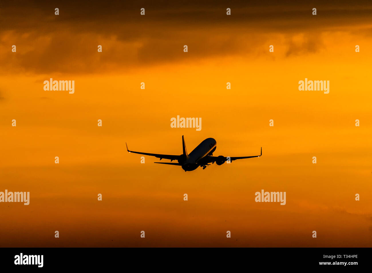 Aircraft taking off at sunset Stock Photo - Alamy