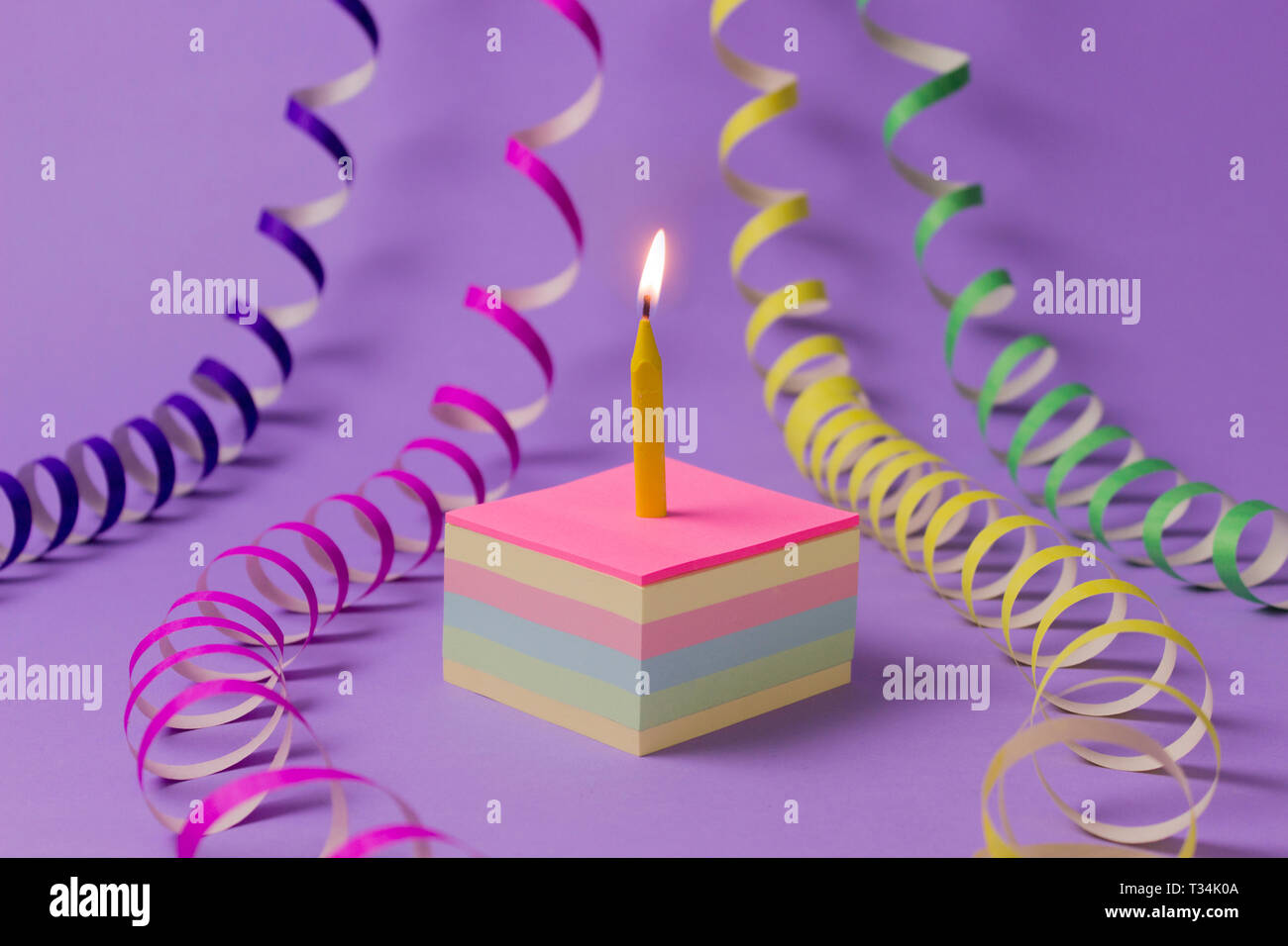 Conceptual birthday cake and streamers Stock Photo - Alamy