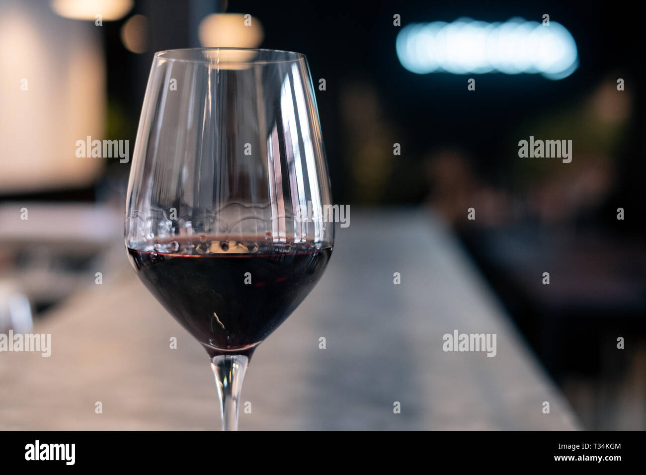Close-up of a glass of red wine on a bar counter Stock Photo - Alamy