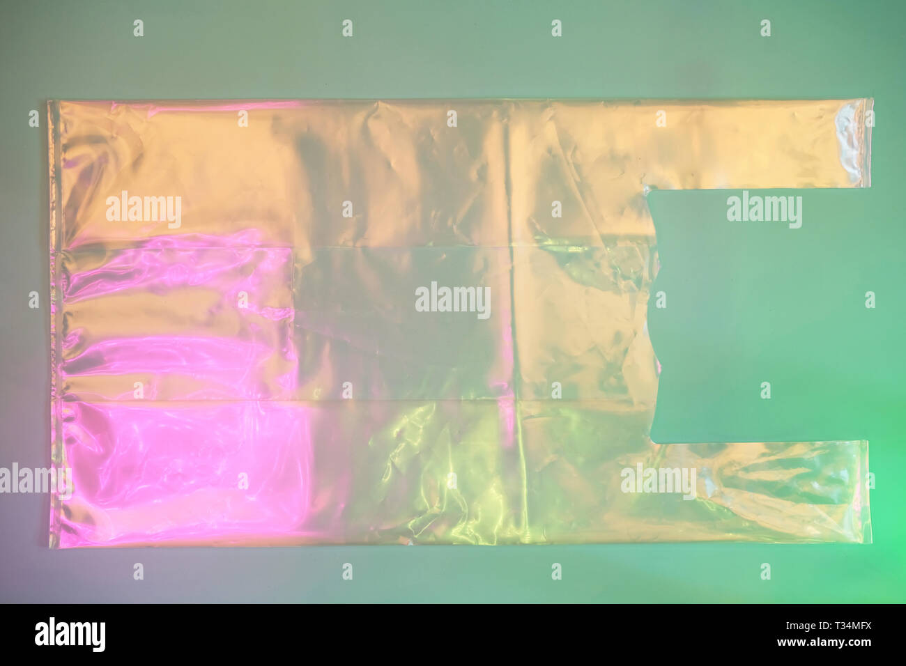 Plastic bag on trendy pink and green background as symbol of a major ...