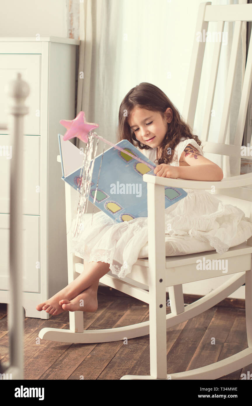 Girl sitting in rocking chair hi-res stock photography and images - Alamy