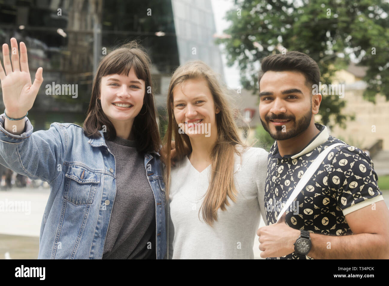 Three people standing outdoors, Germany Stock Photo - Alamy