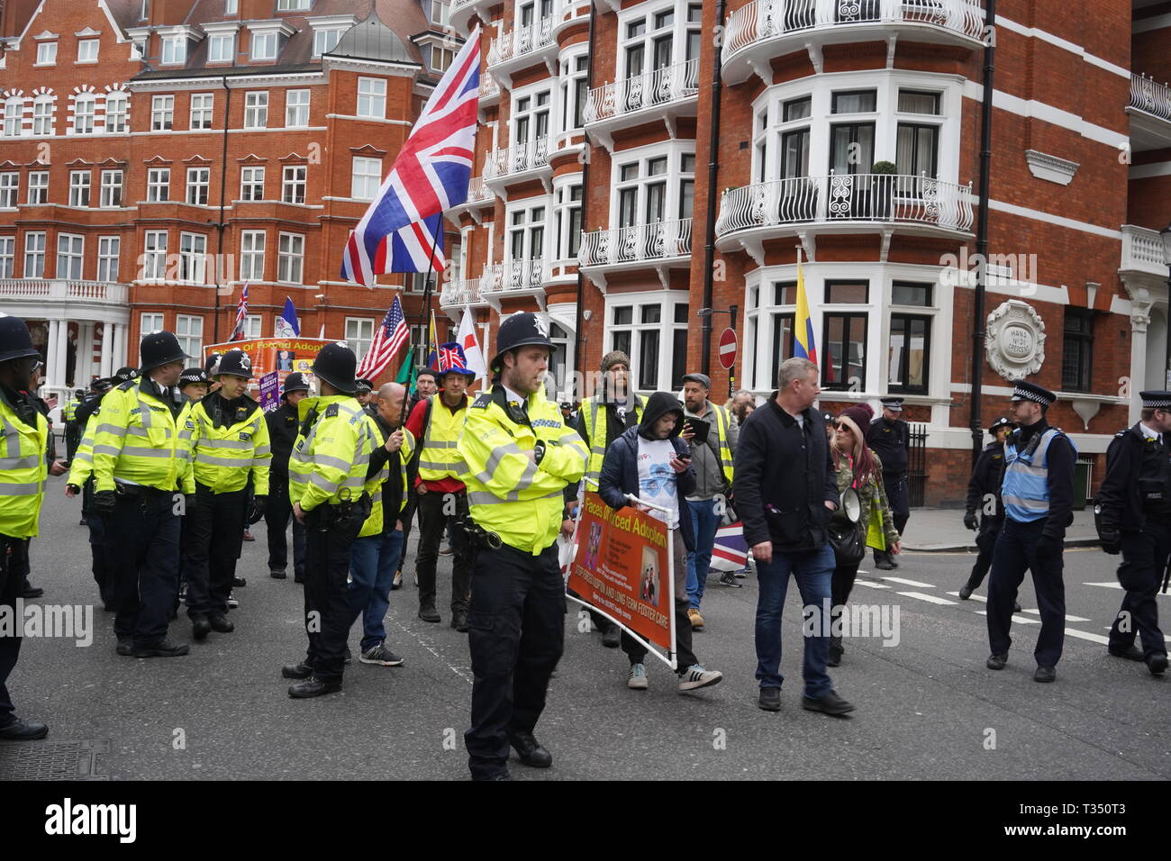 London, UK. 06th April, 2019. Protesters march past the Ecuadorian ...