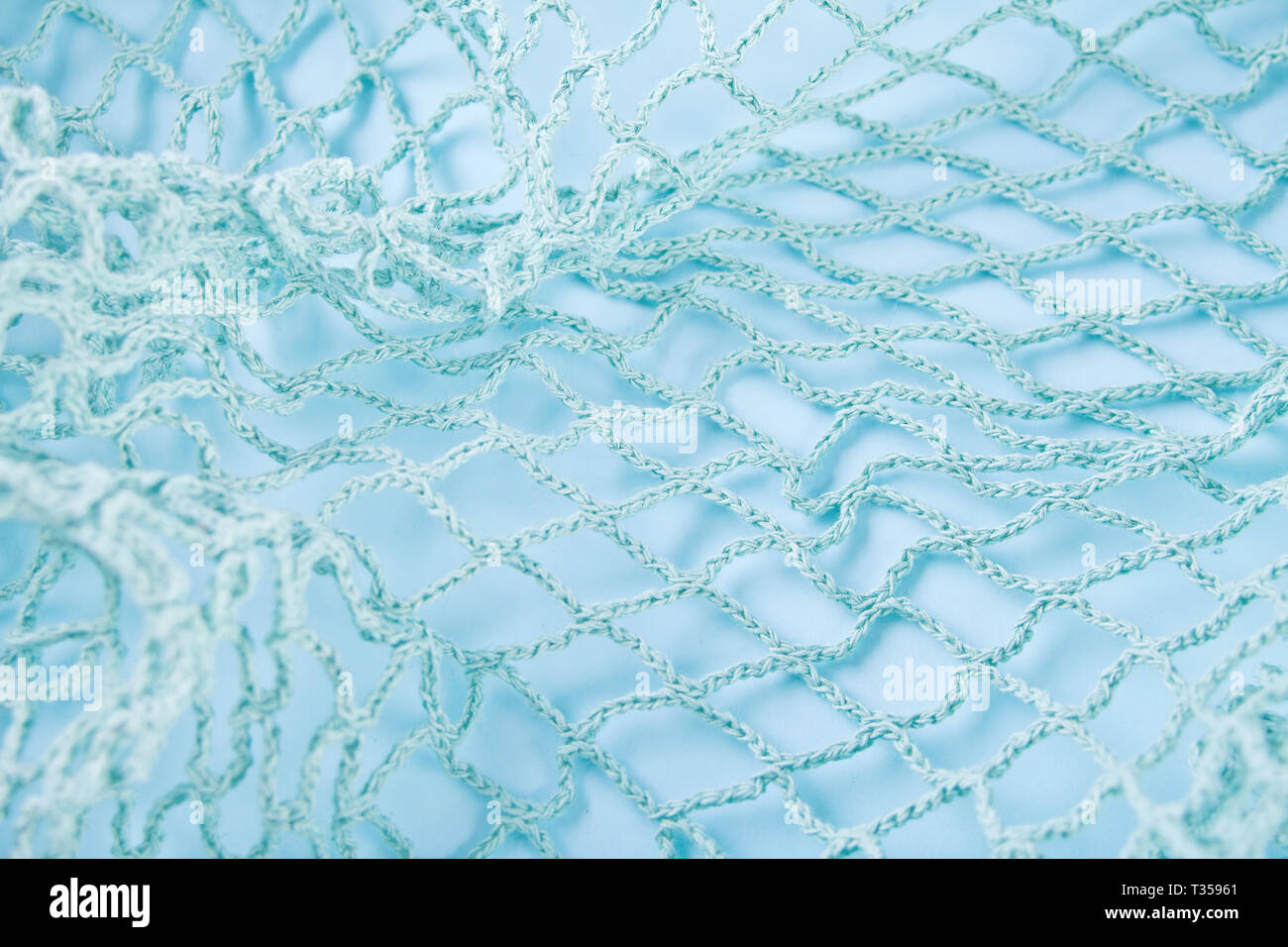 Blue background with blue fishnet. Marine theme Stock Photo - Alamy