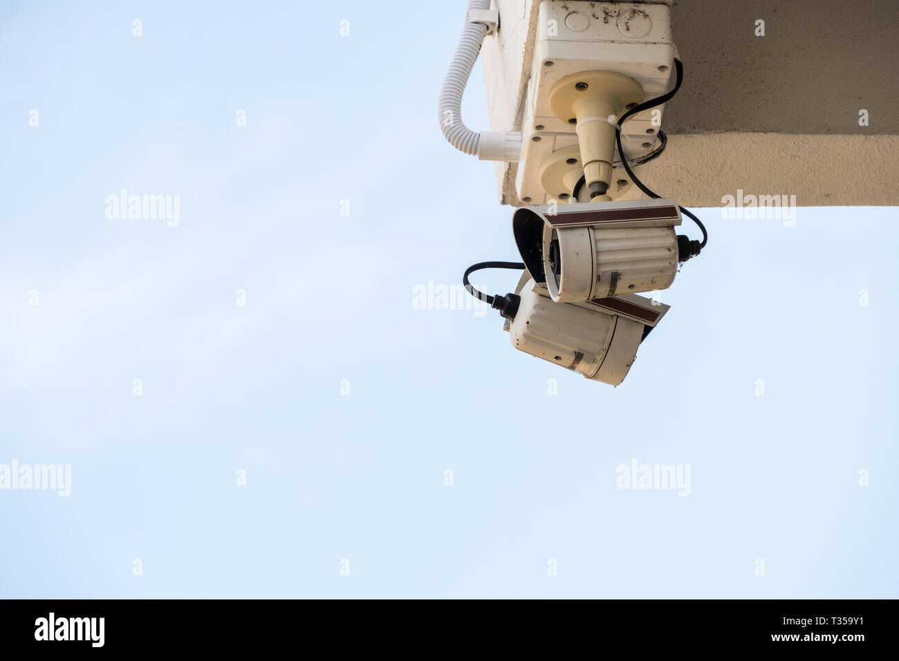 Old security video camera is hanging on the building entrance of the ...