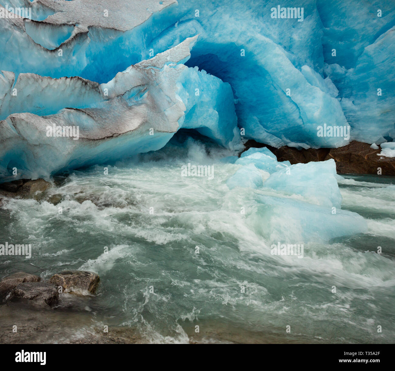 Nigardsbreen Glacier foot cave and melting ice stream close up view ...