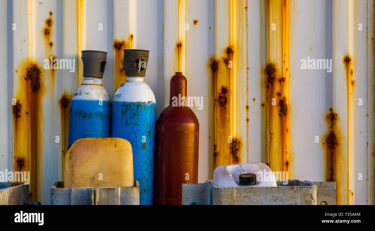 old compressed liquid air bottles standing in front of a rusty ...