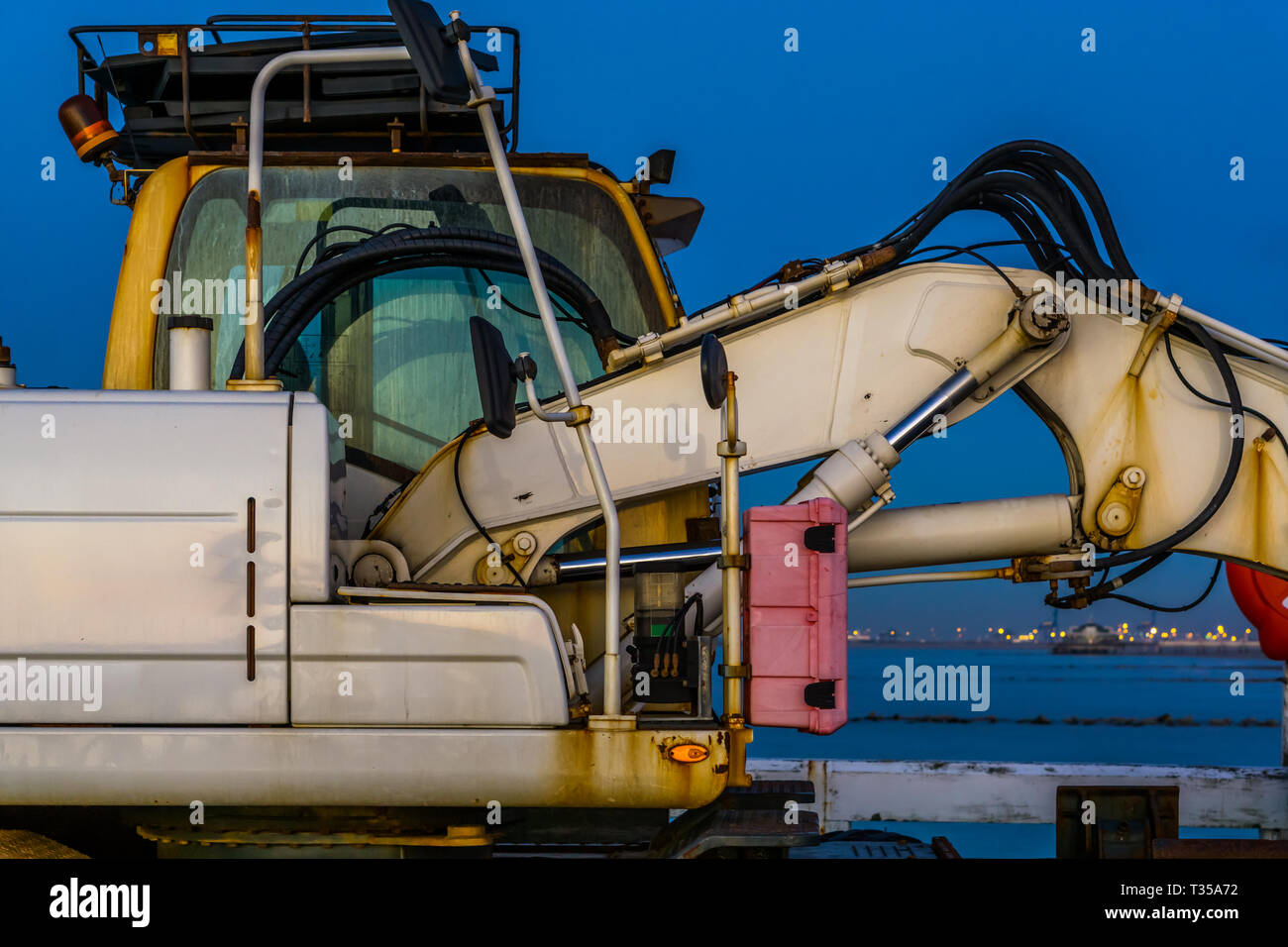 the cabin of a excavator with arm, old rusty digger machine ...