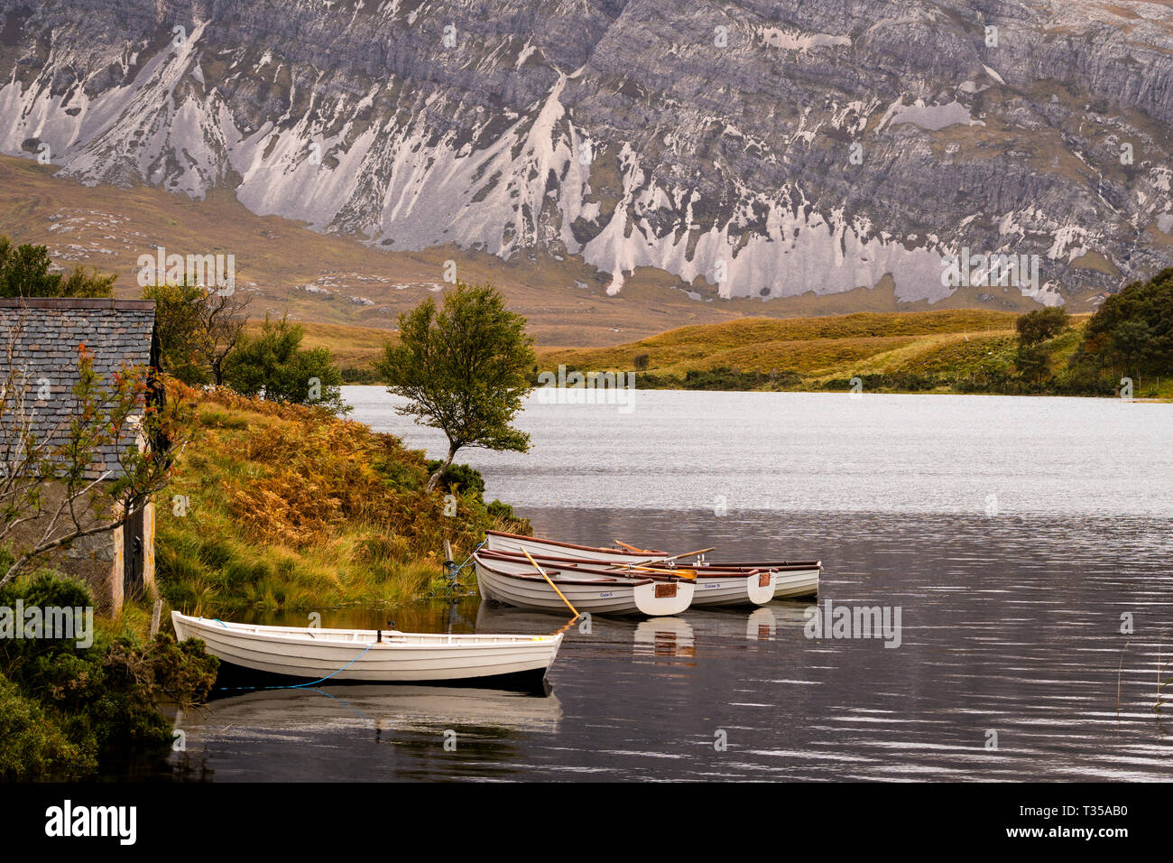 Boathouse and boats on the shore of Loch Stack on the A838 Stock Photo ...