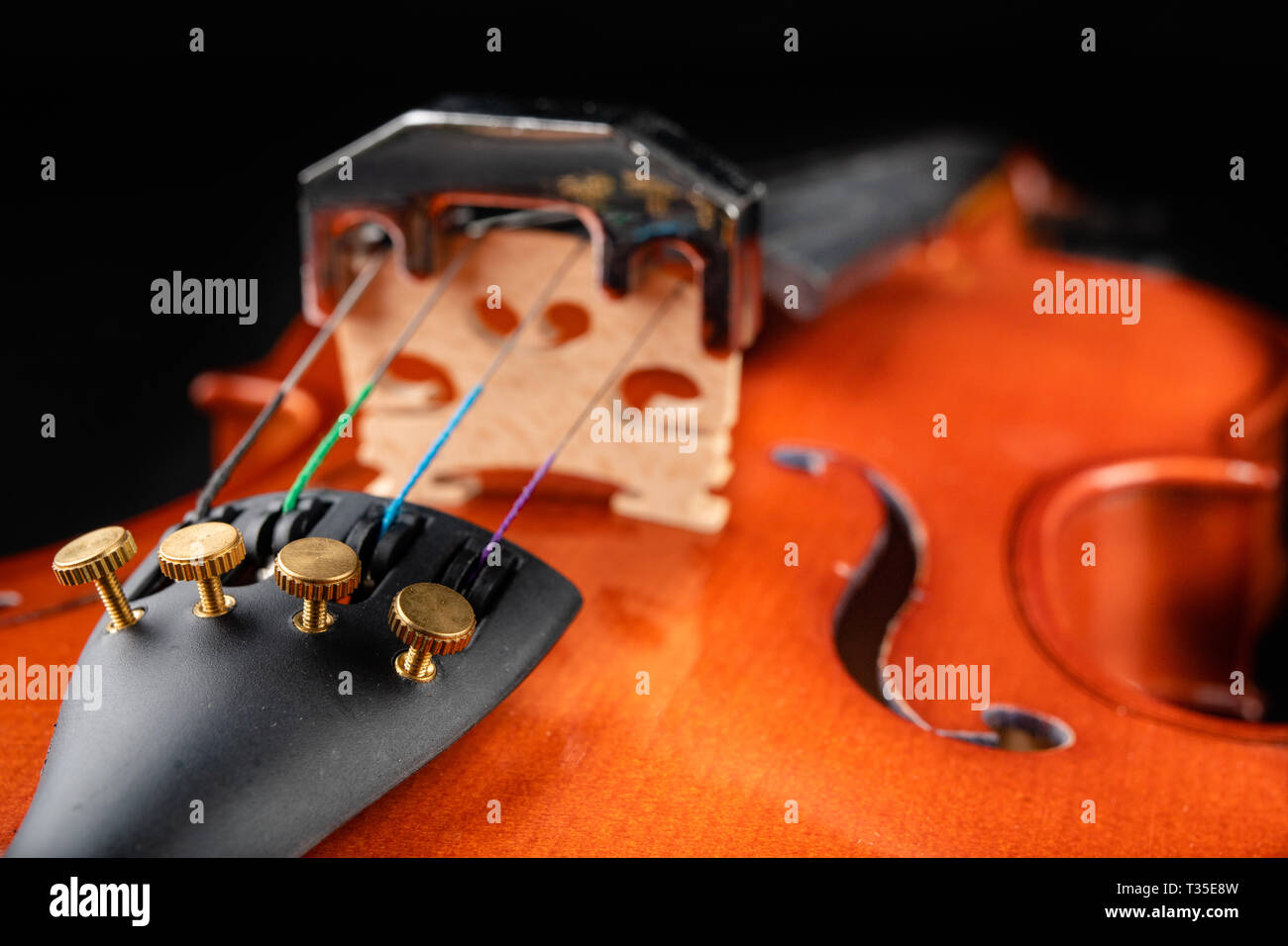 Beautiful new shiny violin on a dark table. Musical string instrument ...