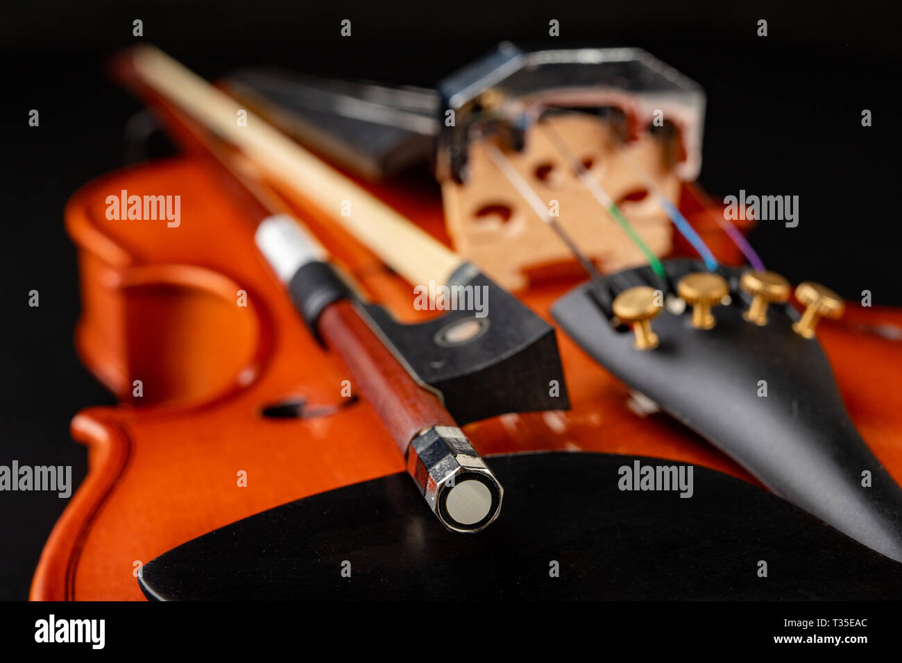Beautiful new shiny violin on a dark table. Musical string instrument ...