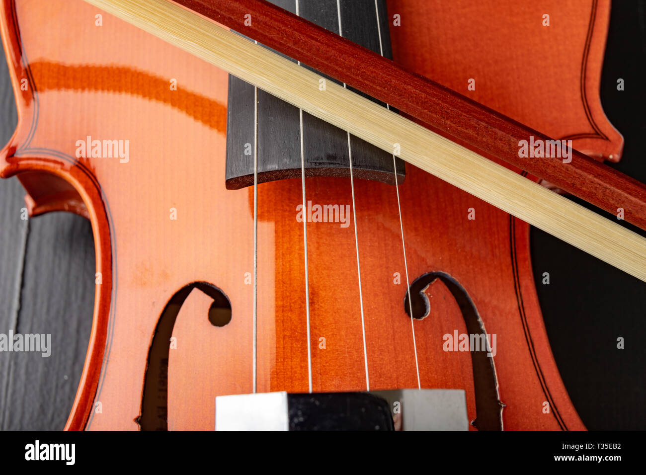 Beautiful new shiny violin on a dark table. Musical string instrument ...