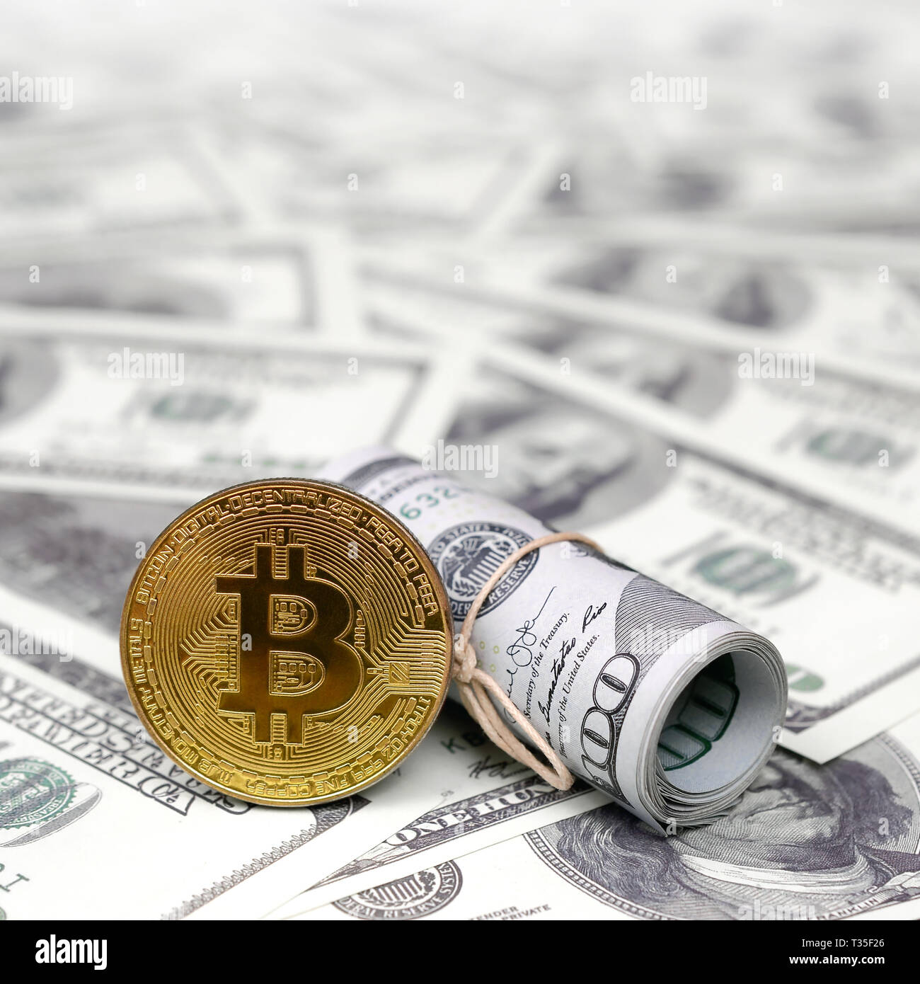 Bitcoin coin and banknotes of one hundred dollar. Conceptual image for ...