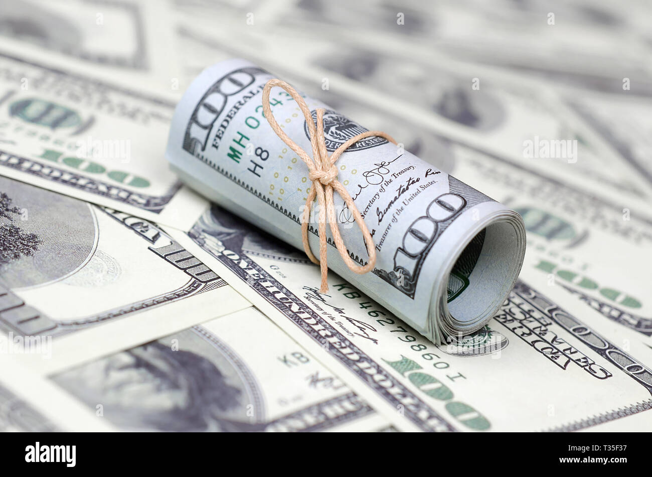 US dollars rolled up and tightened with band lies on a lot of american ...