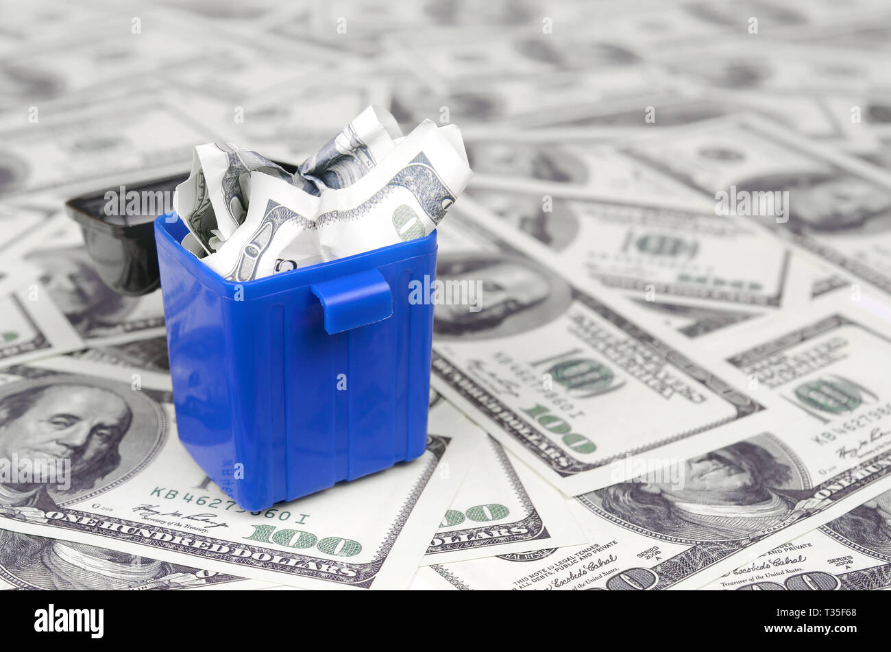American cash notes are thrown into the trash bin on a multitude of ...