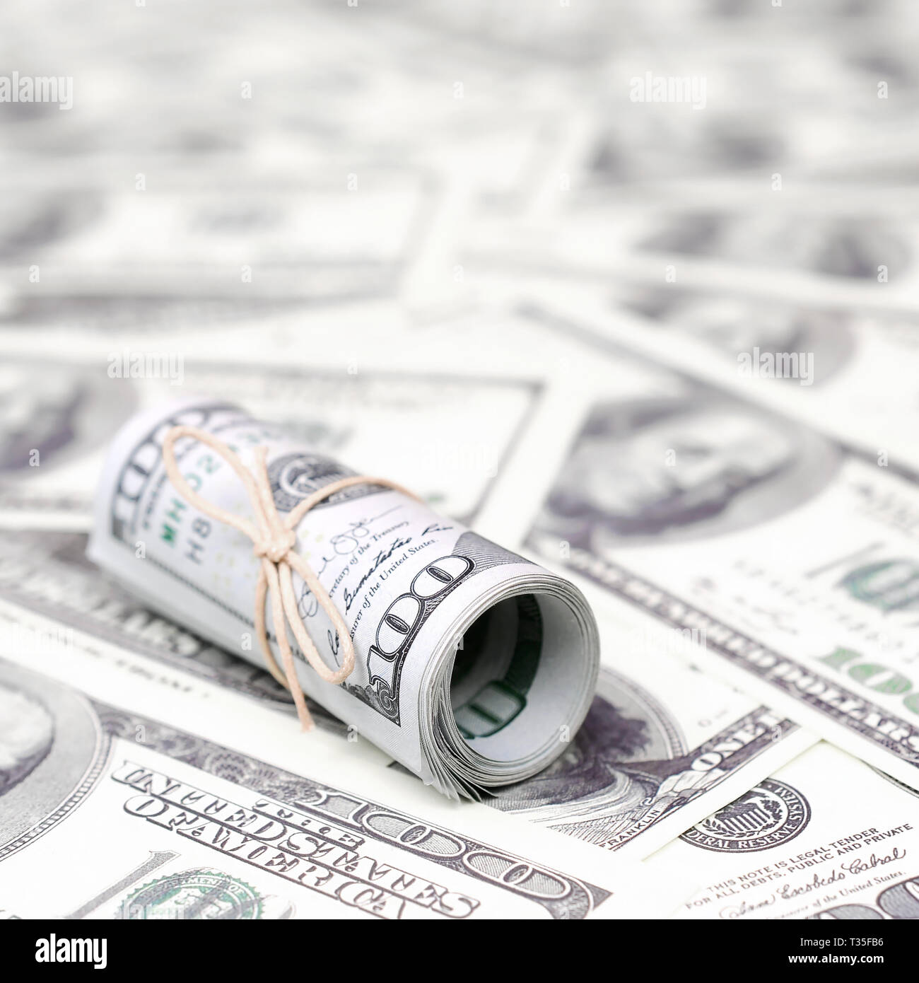 US dollars rolled up and tightened with band lies on a lot of american ...