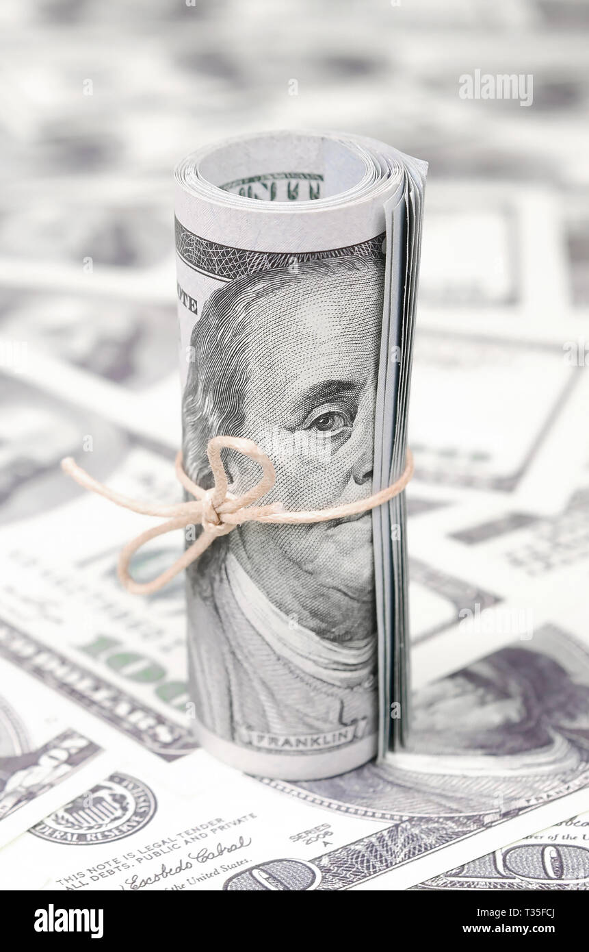 US dollars rolled up and tightened with band lies on a lot of american ...