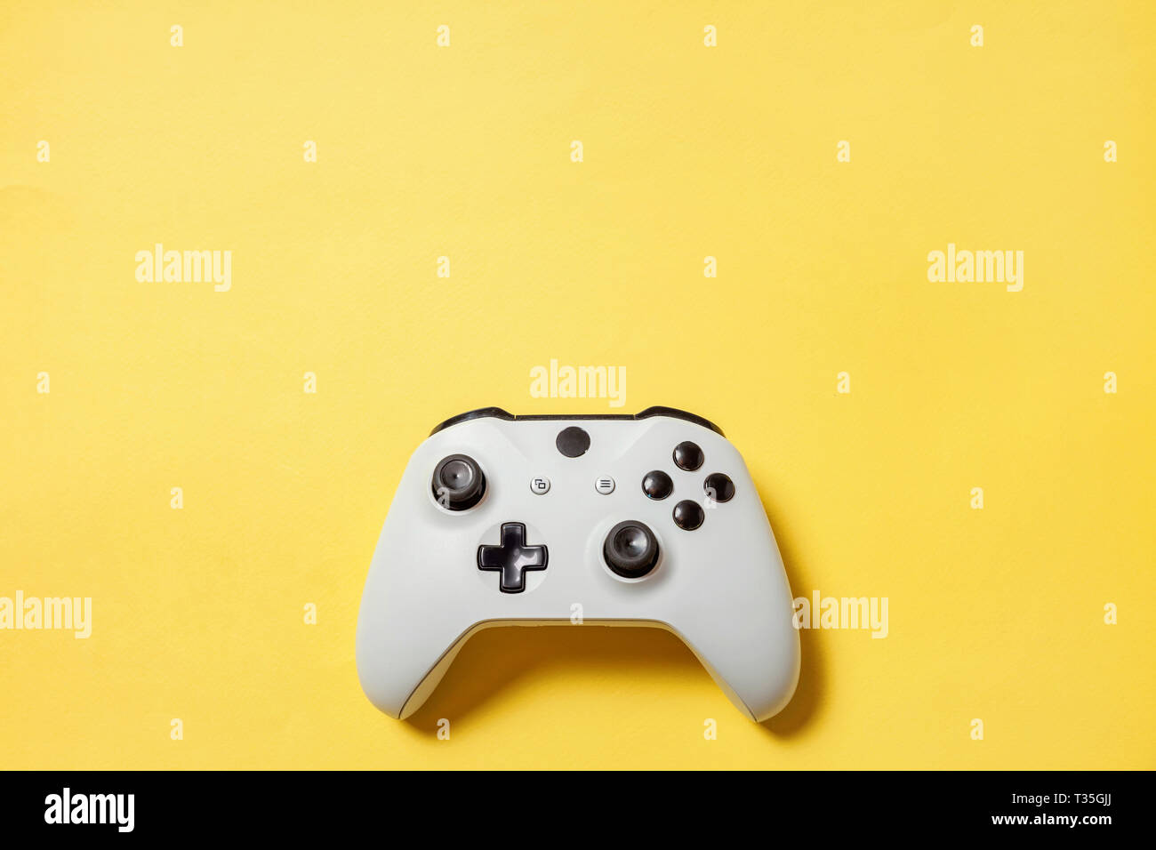 White joystick gamepad, game console on yellow colourful trendy modern ...