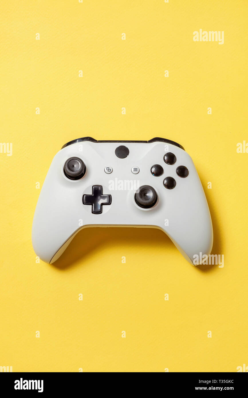 White joystick gamepad, game console on yellow colourful trendy modern ...