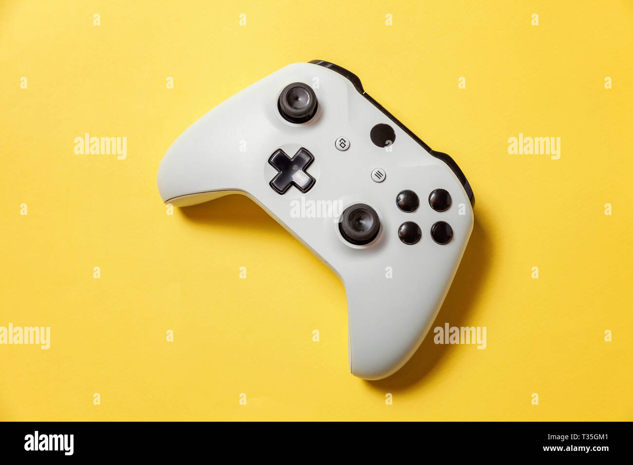 White joystick gamepad, game console on yellow colourful trendy modern ...