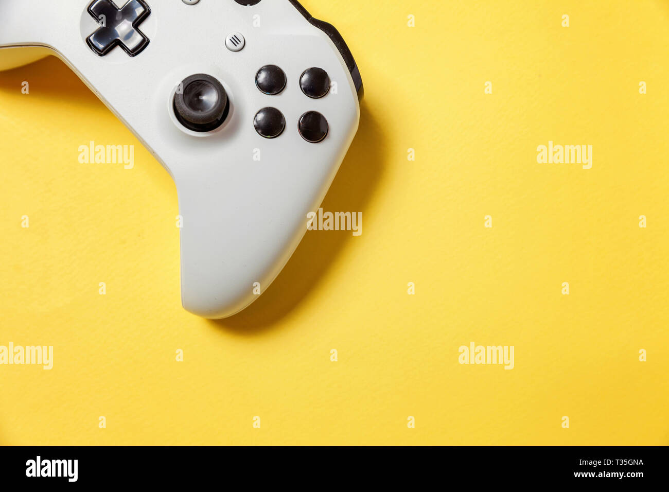 White joystick gamepad, game console on yellow colourful trendy modern ...