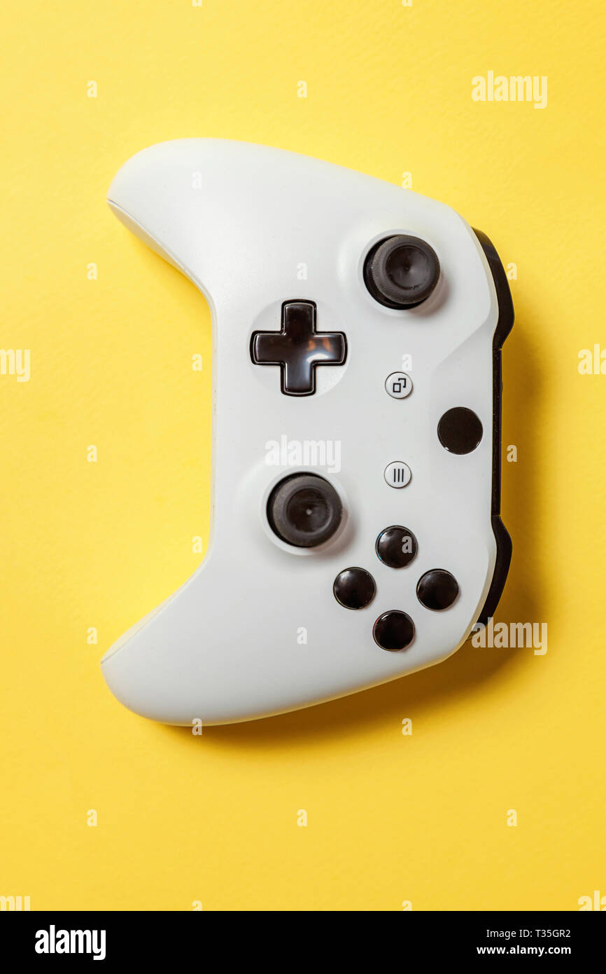 White joystick gamepad, game console on yellow colourful trendy modern ...
