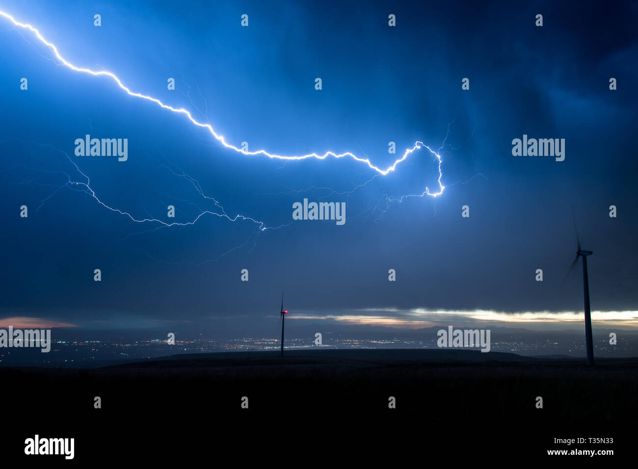 Lightning over city at night Stock Photo - Alamy