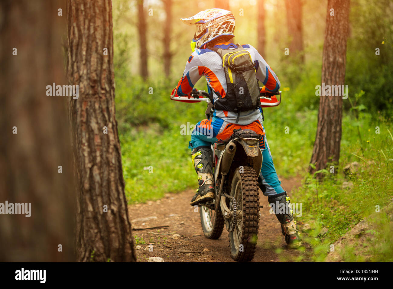 Motocross racer racing on the off-road circuit mud flying Stock Photo ...