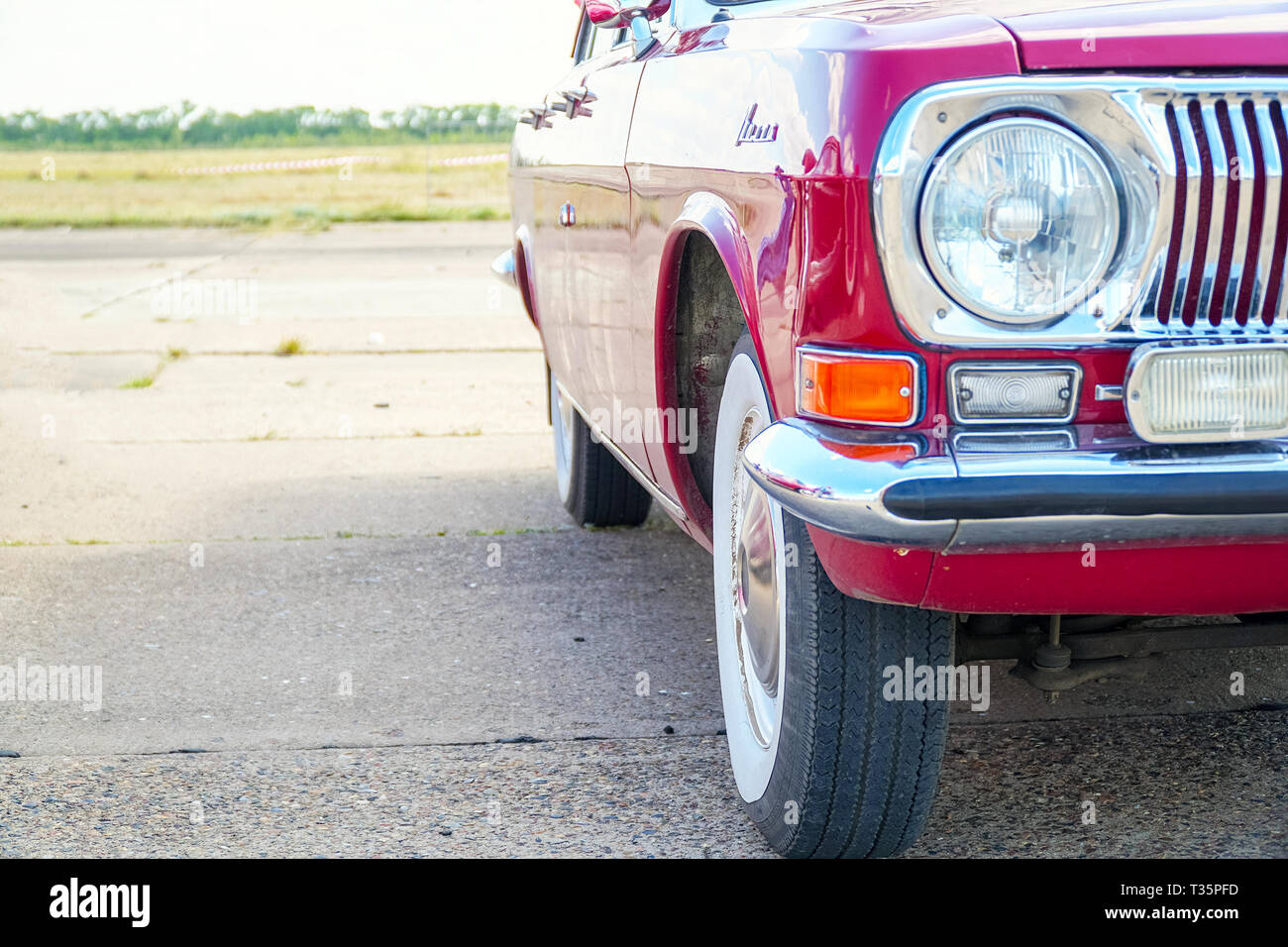 Radiator, bumper and headlight of red vintage car Stock Photo - Alamy