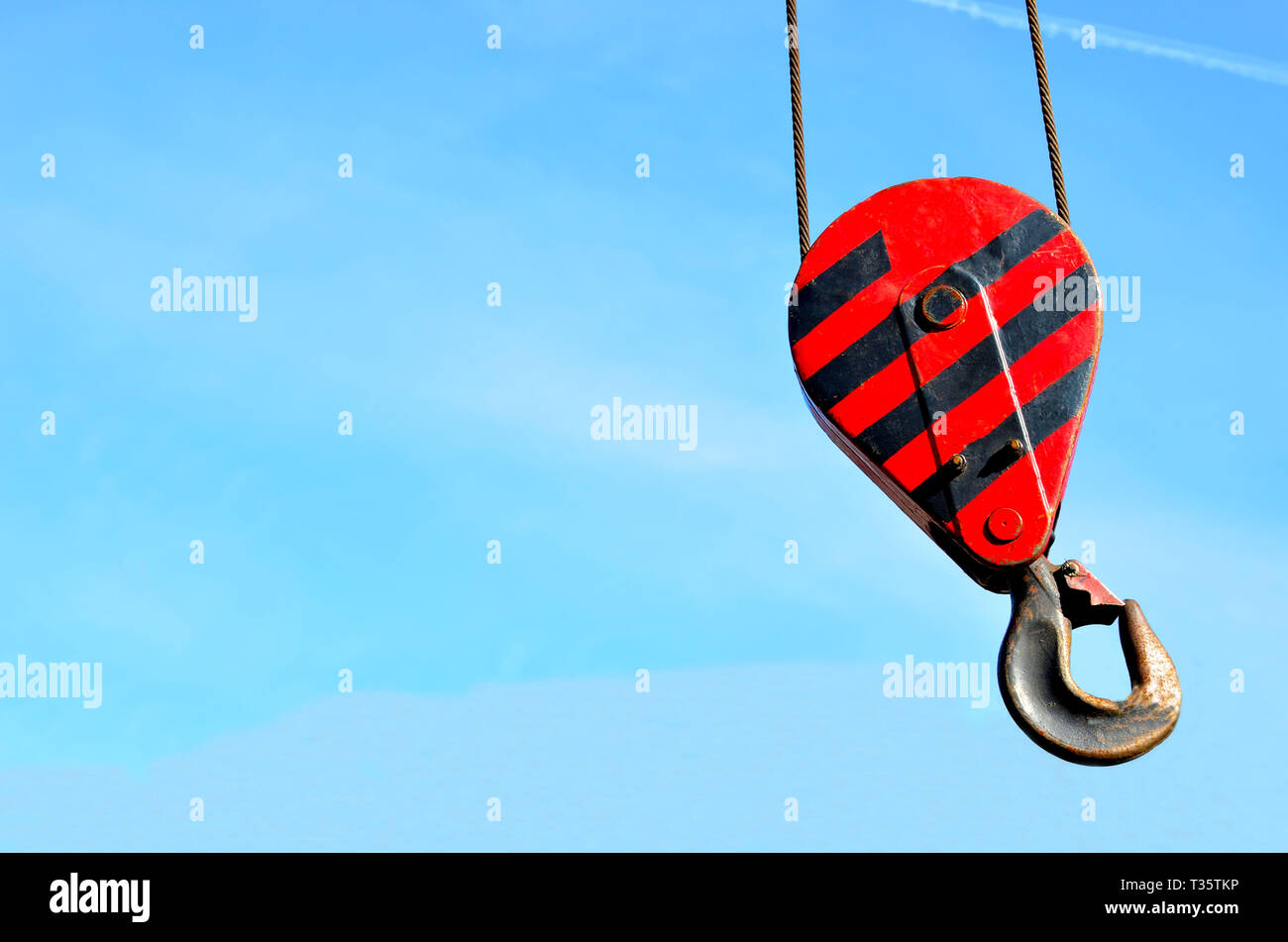 Large iron crane hook for lifting heavy loads during construction, on ...