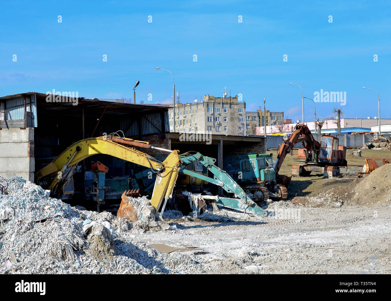 Old rusty abandoned construction excavators with a bucket on the ground ...